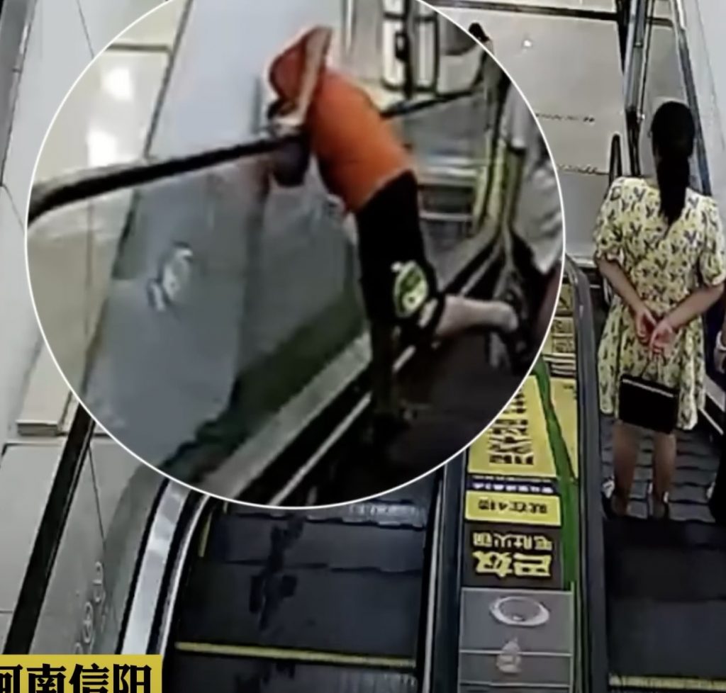 Boy leans over escalator handrail, gets head stuck in between wall ...