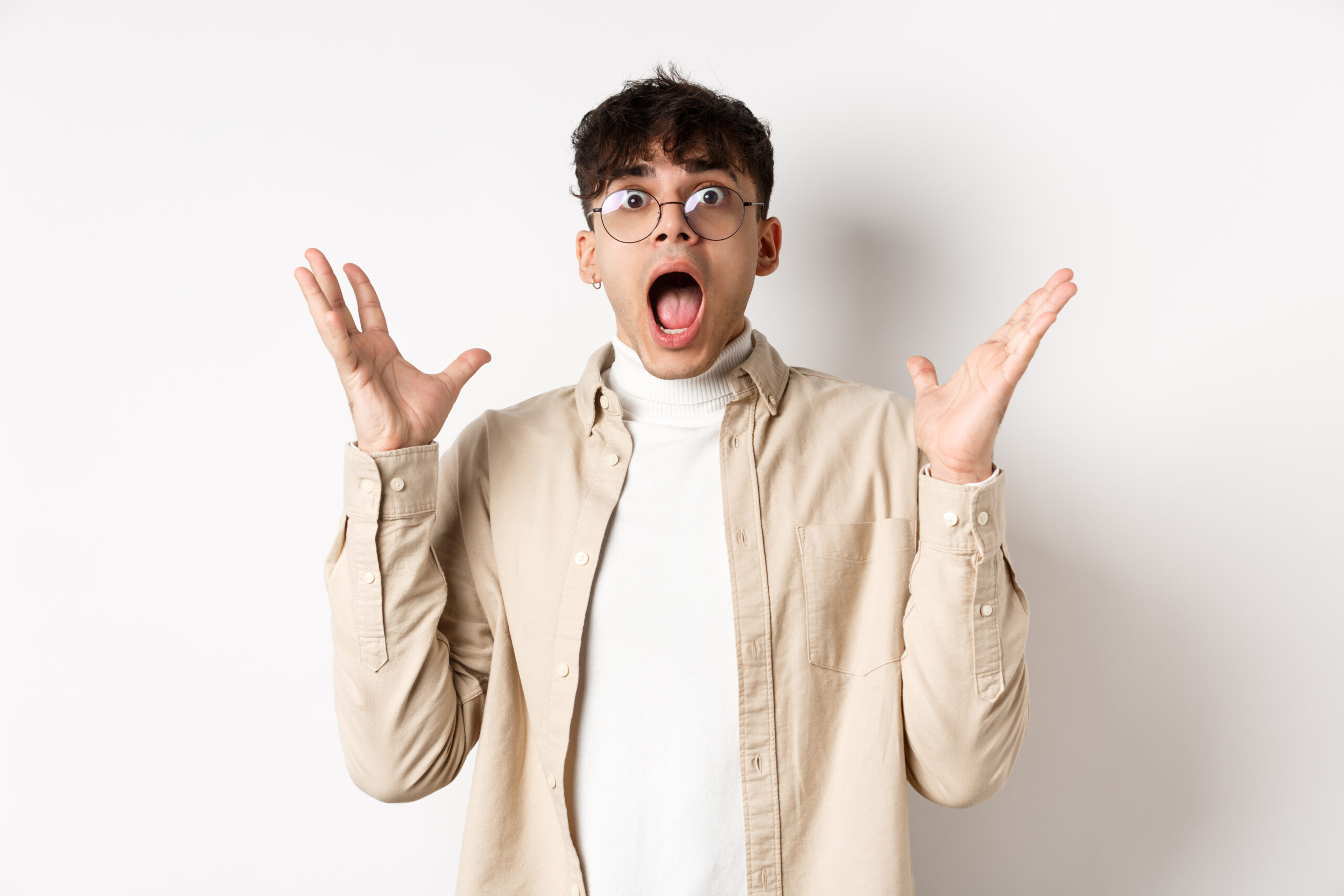 Scared young man in panic, screaming and looking axious, jumping ...